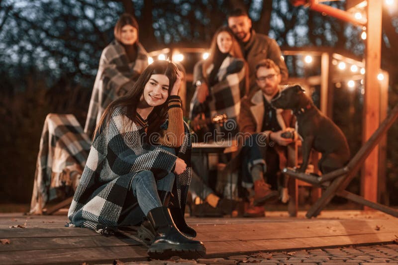 Portrait is Sitting in Front of Her Friends. Group of People is ...