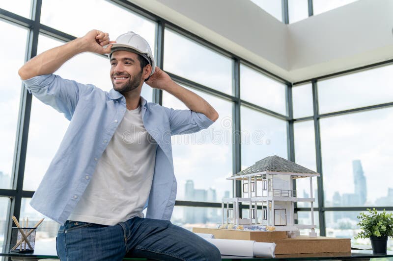 Skilled Architect Engineer Wear Safety Helmet while Sitting on Table ...