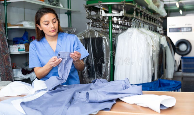 Portrait of Female Laundry Worker Examining Clean Garments Stock Image ...