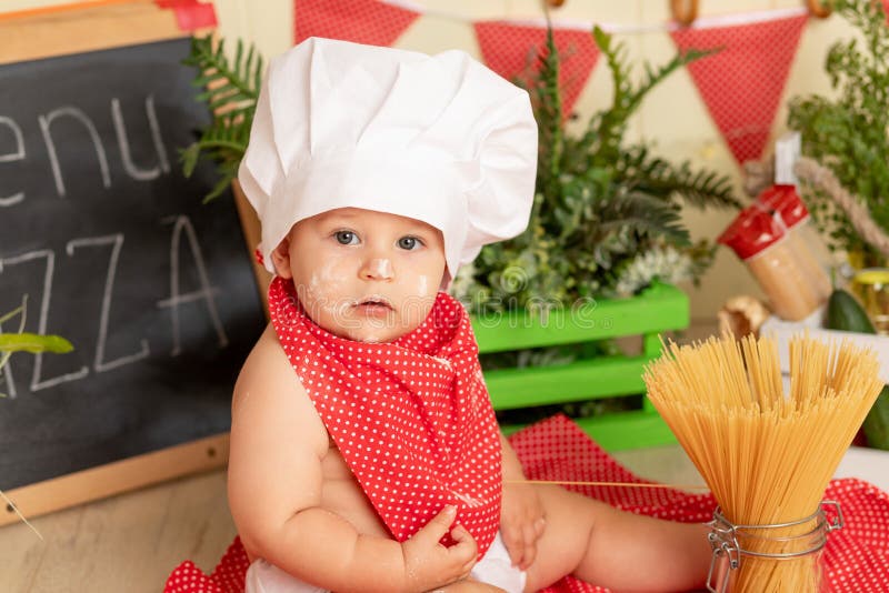 Portrait of a Small Child in a Chef`s Hat Preparing Spaghetti in the ...