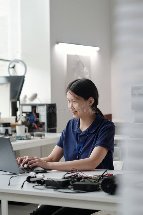 Portrait of Smiling Asian Woman Using Laptop in Modern Office Stock ...