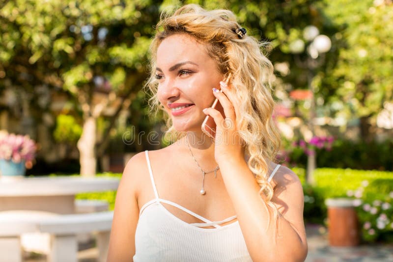Portrait of a Smiling Beautiful Woman Talking on the Phone Stock Photo ...