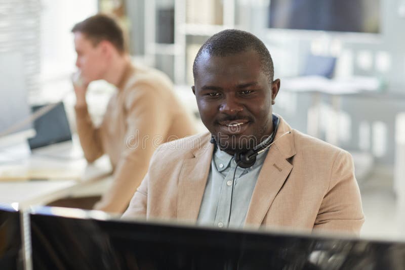 Smiling Black Man Looking at Computer in Customer Support Center Stock ...