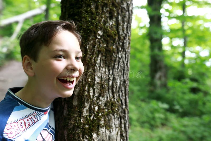 Portrait of Smiling Boy in Forest Stock Image - Image of enjoyment ...