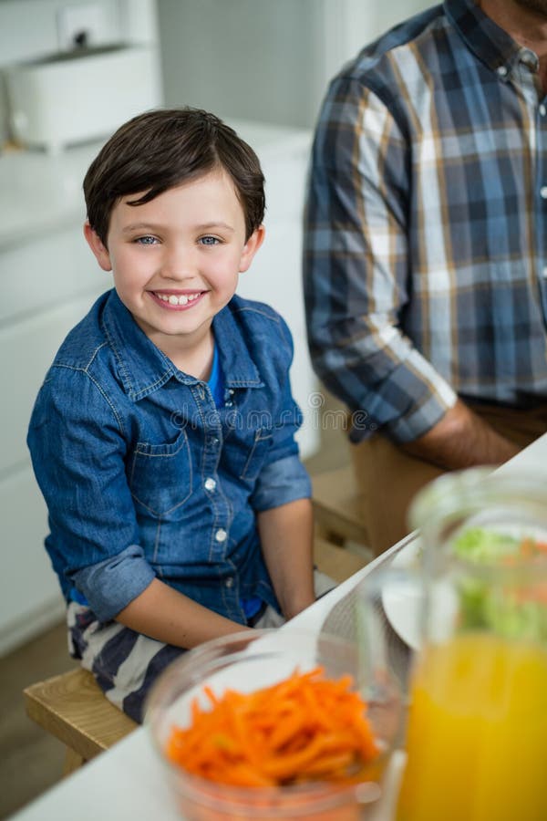Portrait of Smiling Boy Sitting at Dining Table Stock Image - Image of ...