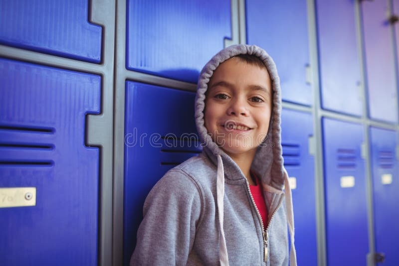 Portrait of Smiling Boy Standing by Lockers Stock Photo - Image of ...
