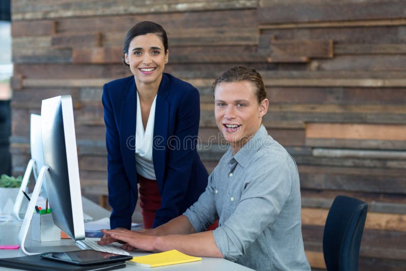 Portrait of Smiling Businesspeople Working on Personal Computer Stock ...