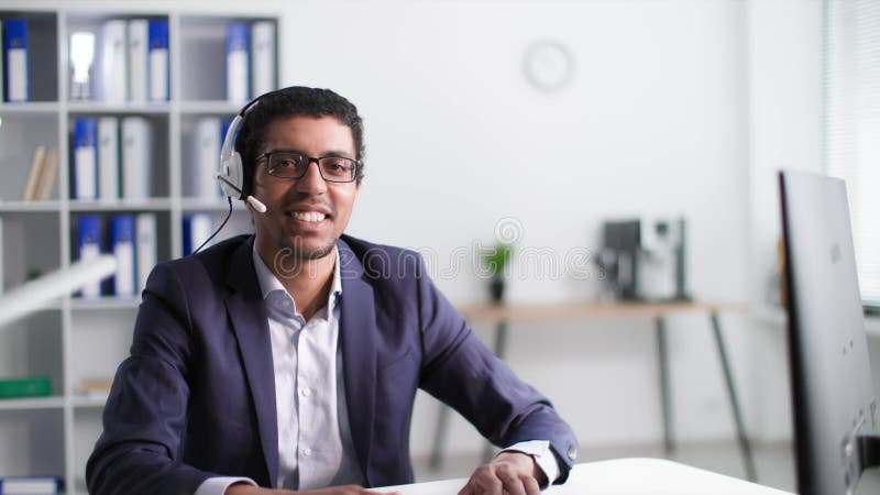 Portrait of Smiling Call Center Employee in Glasses and with a Headset ...
