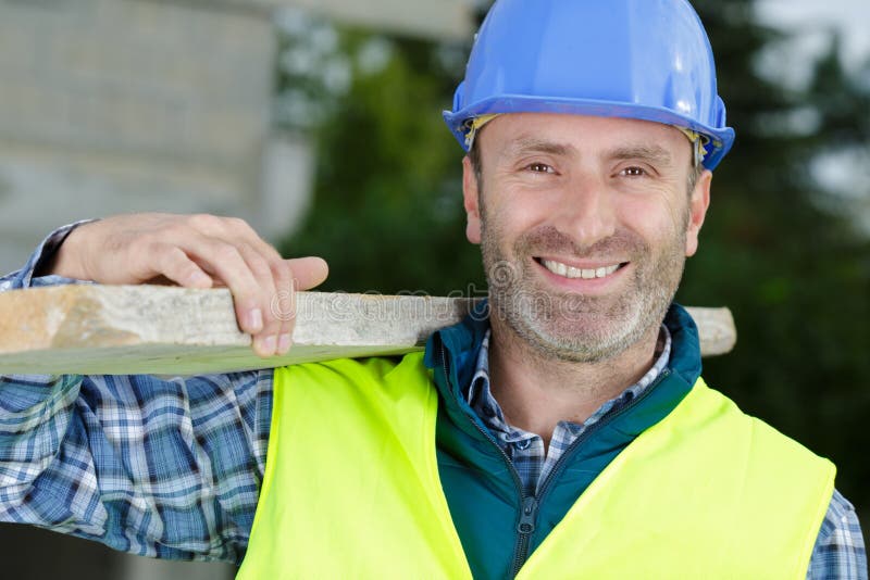 Portrait Smiling Carpenter Holding Wood Planks Stock Photo - Image of ...