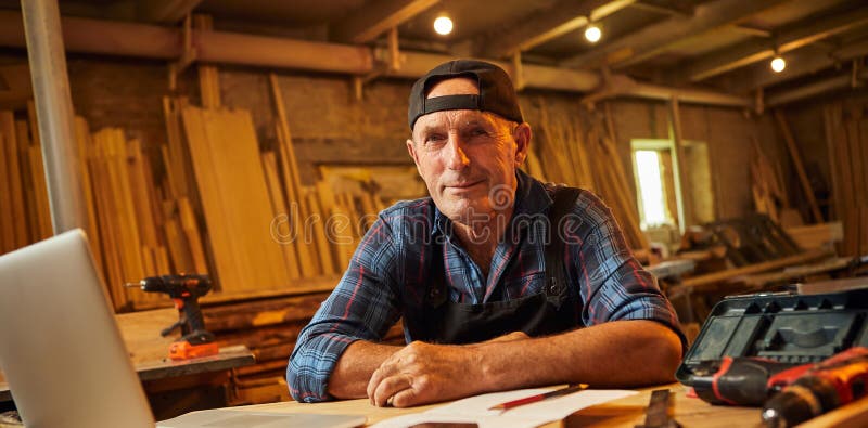 Portrait of Smiling Carpenter Works on the Computer in the Workshop ...