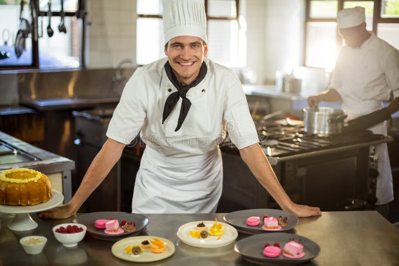 Portrait of Smiling Chef Presenting Dessert Plates Stock Image - Image ...
