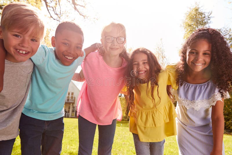 Portrait of Smiling Children Outdoors at Home Looking into Camera Stock ...