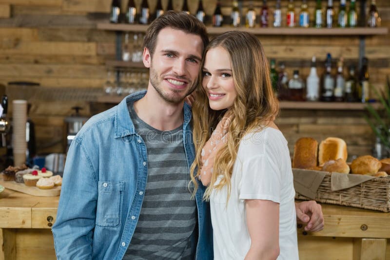 Portrait of Smiling Couple Standing Behind the Counter Stock Photo ...