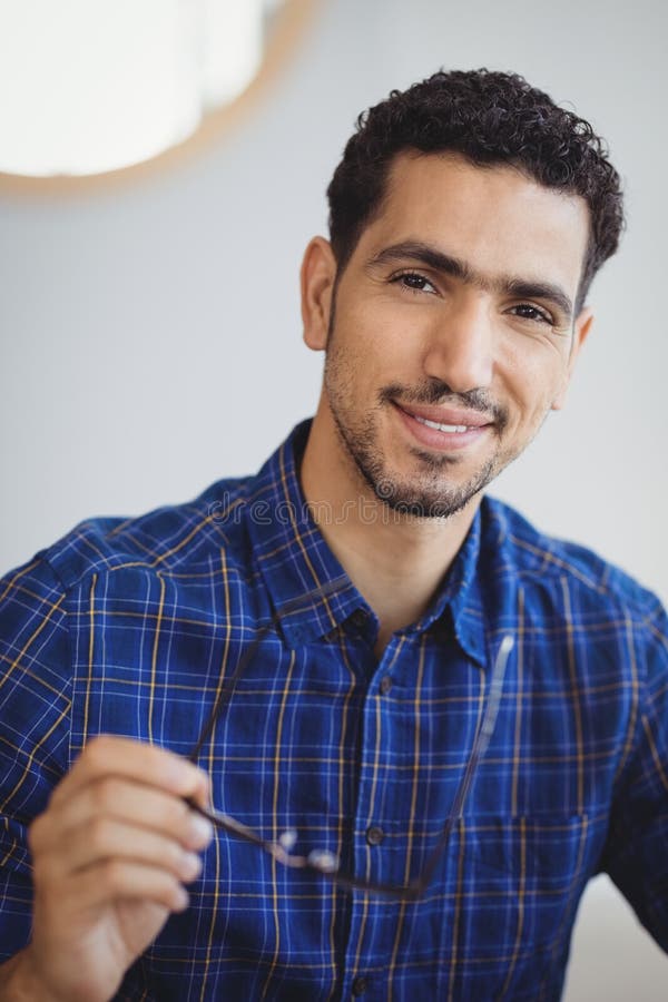 Portrait of Smiling Executive Holding Spectacles Stock Image - Image of ...