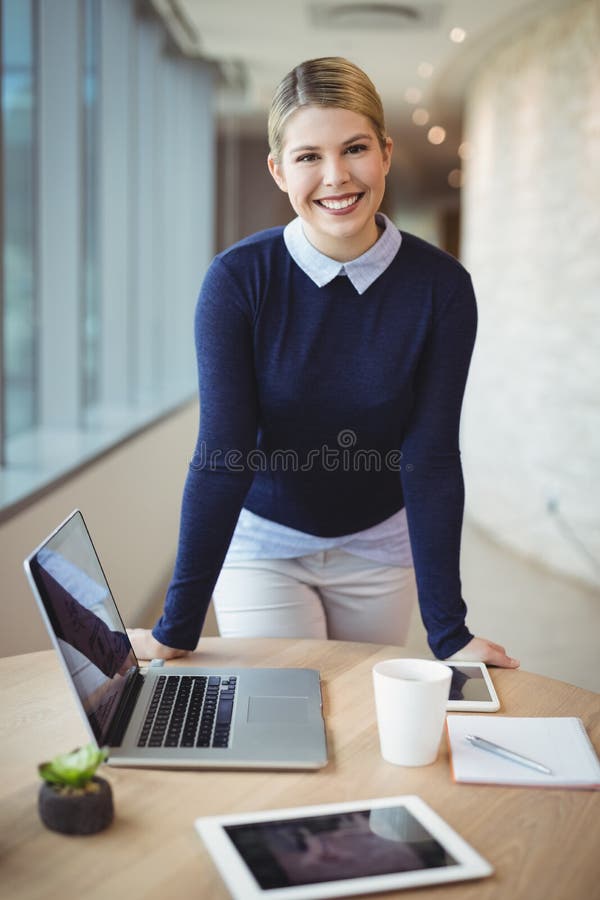 Portrait of Smiling Executive Standing at Desk Stock Image - Image of ...