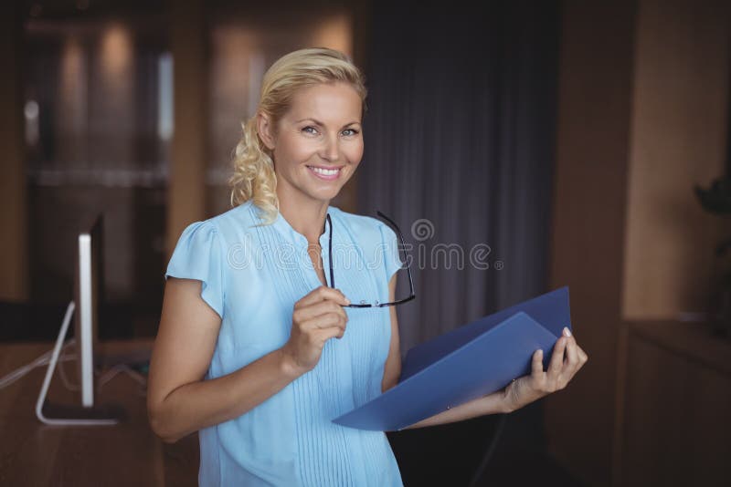 Portrait of Smiling Executive Standing with File Stock Photo - Image of ...
