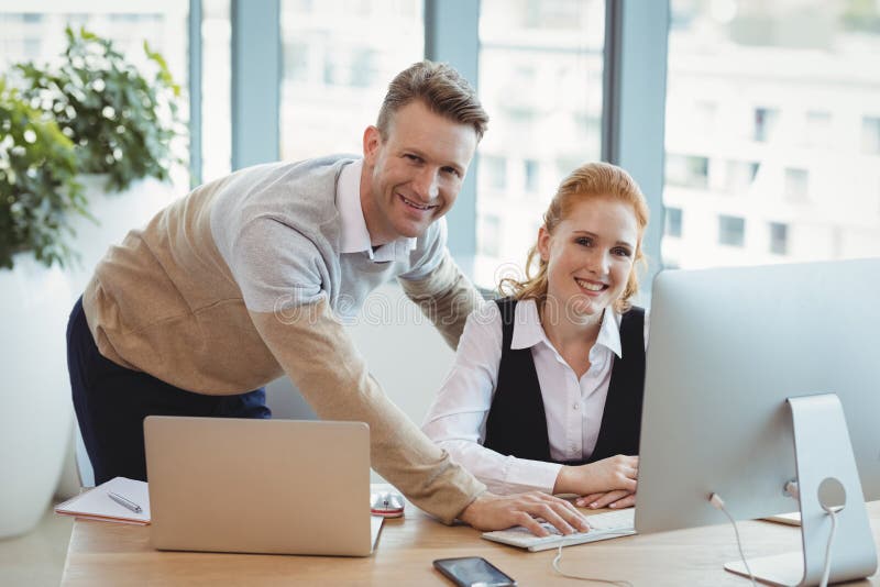 Portrait of Smiling Executives Working at Desk Stock Image - Image of ...