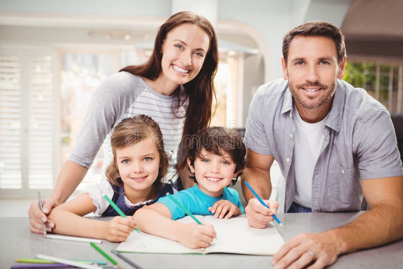 Portrait of Smiling Family Writing in Book Stock Photo - Image of book ...