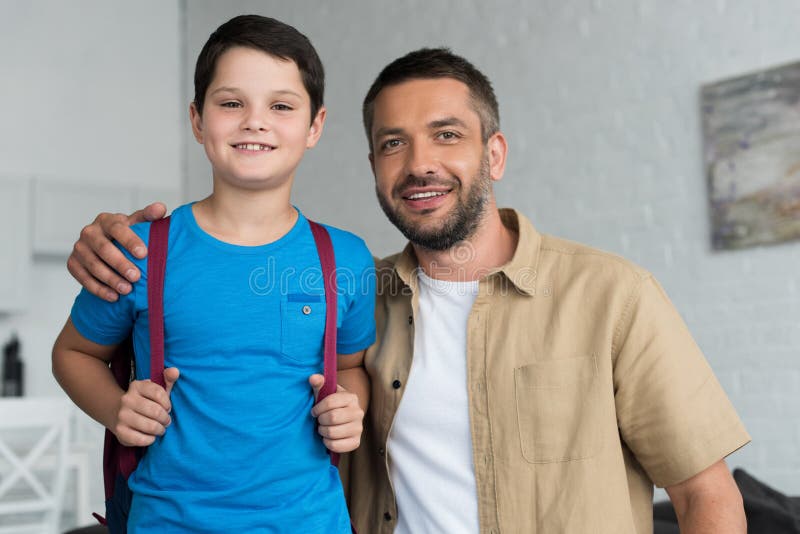 Portrait of Smiling Father and Son with Backpack at Home Back To Stock ...