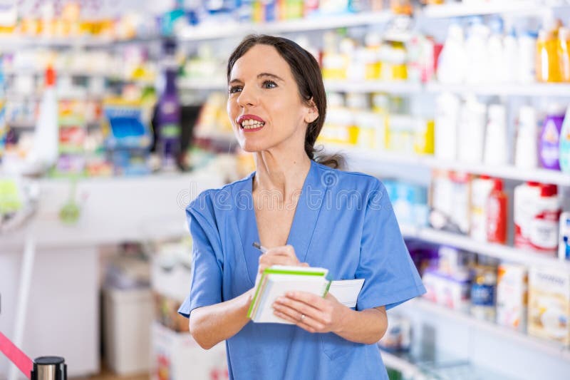 Portrait of Smiling Female Druggist Making Notes Stock Image - Image of ...