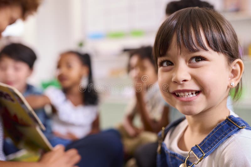 Portrait of Smiling Female Elementary School Pupil Sitting in Classroom ...