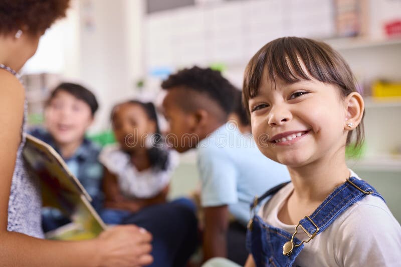 Portrait of Smiling Female Elementary School Pupil Sitting in Classroom ...