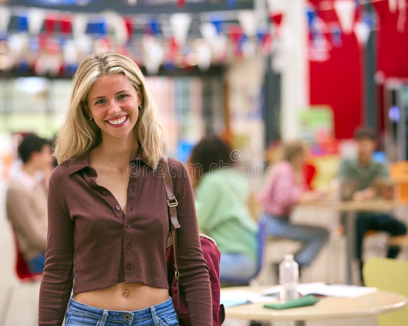 Portrait of Smiling Female University Student Standing Inside College ...