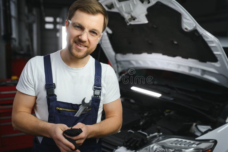 Portrait of a Smiling Fixing a Car Engine in His Garage Stock Image ... Portrait of a Smiling Fixing a Car Engine in His Garage Stock Image ...