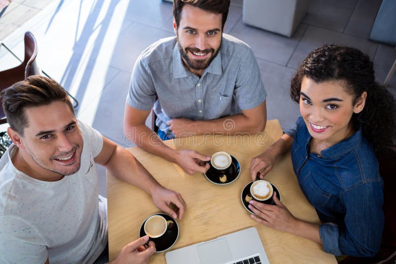 Portrait of Smiling Friends Sitting at a Table Stock Photo - Image of ...