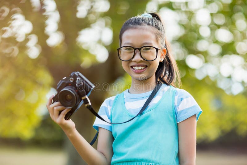 Portrait of Smiling Girl in Spectacle Holding a Camera Stock Image ...