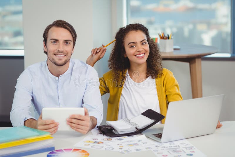 Portrait of Smiling Graphic Designers Sitting at Table Stock Photo ...