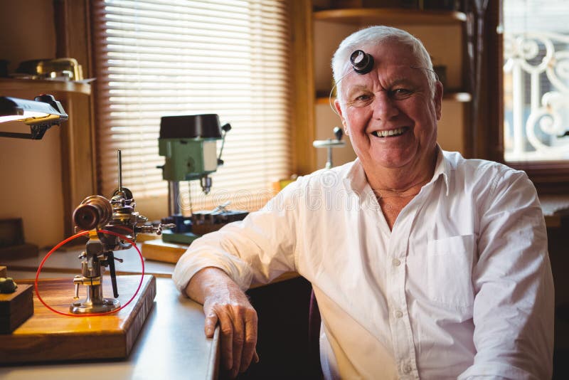 Smiling Horologist Examining Clock Parts in Workshop Stock Photo ...