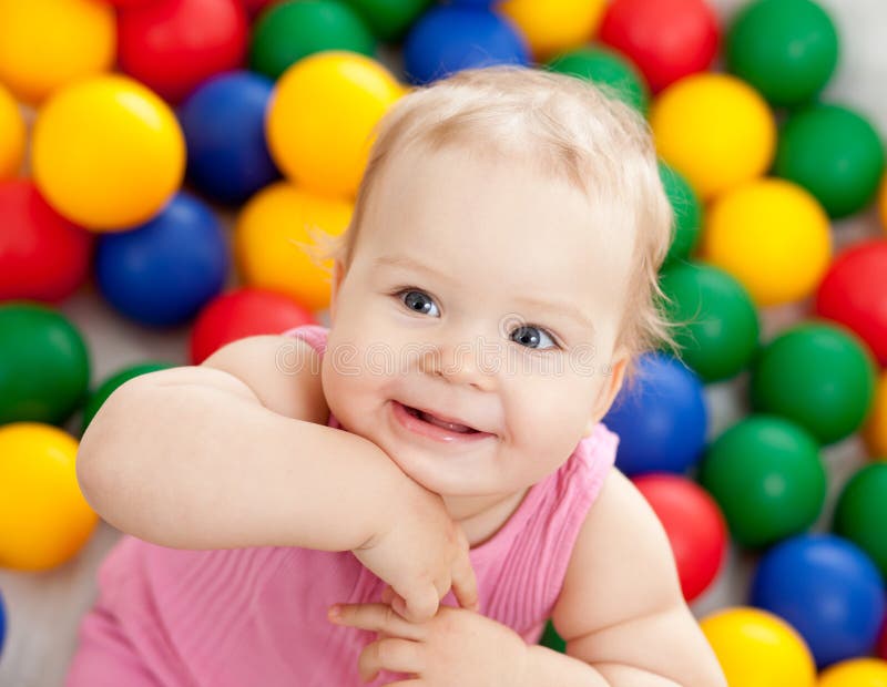 Portrait of a Smiling Infant among Colorful Balls Stock Photo - Image ...