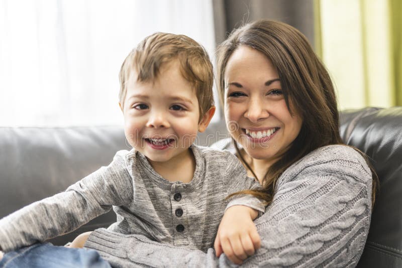 Portrait of Smiling Little Boy with Mother on Sofa Stock Image - Image ...