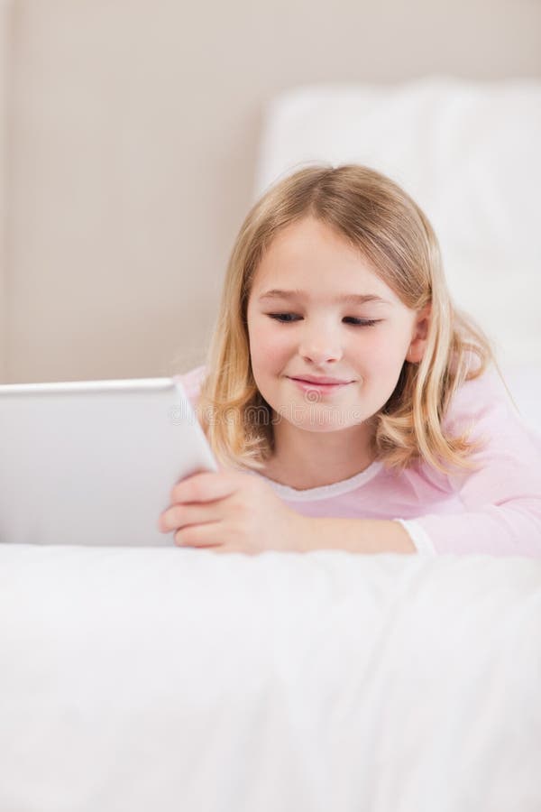 Portrait of a Smiling Little Girl Using a Tablet Computer Stock Image ...
