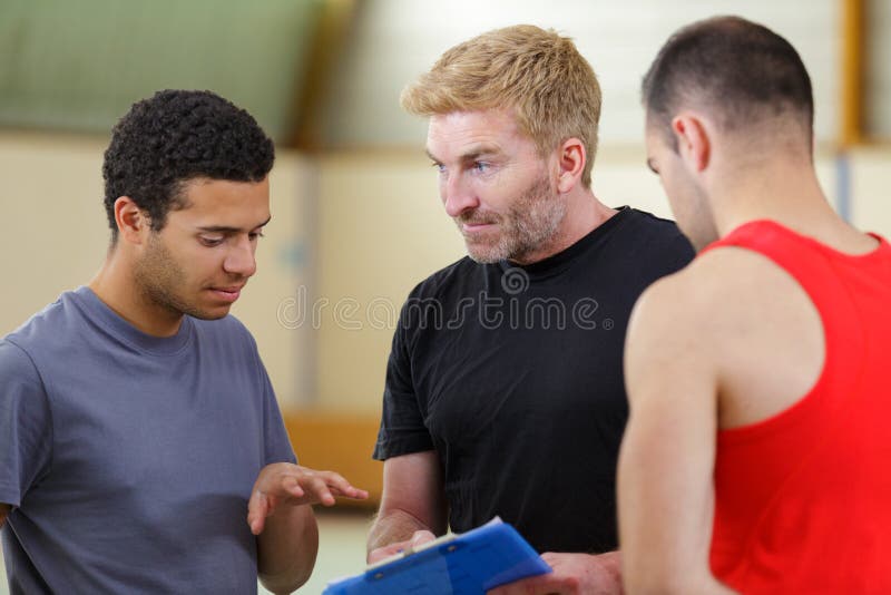 Portrait Smiling Male Coach Standing with Players Stock Photo - Image ...