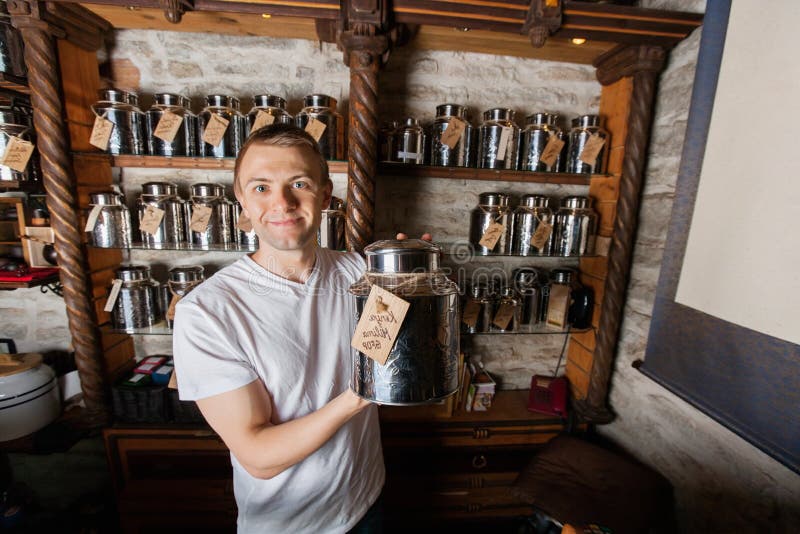 Portrait of Smiling Male Owner Displaying Tea Container in Store Stock ...