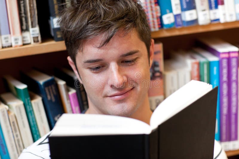 Portrait of a Smiling Male Student Reading a Book Stock Photo - Image ...