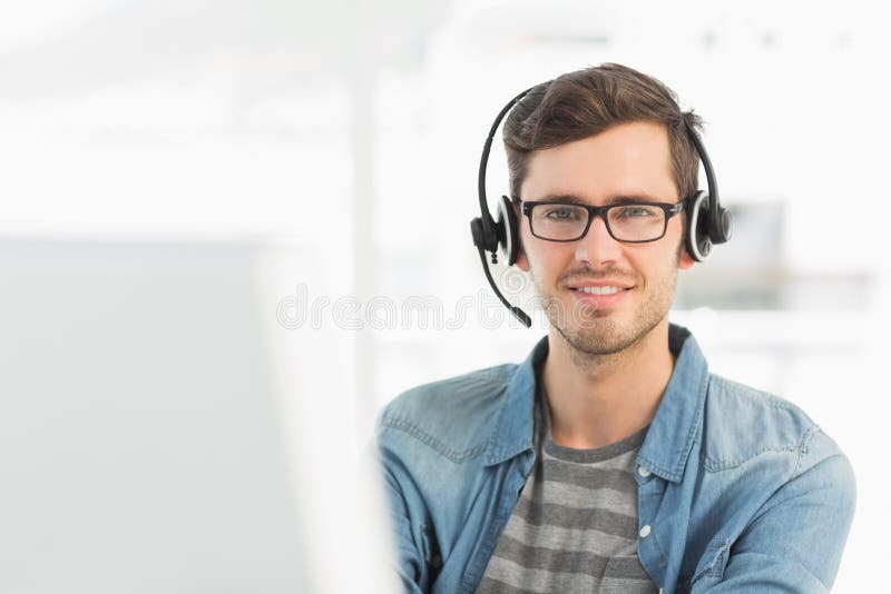 Portrait of a Smiling Man with Headset Using Computer Stock Photo ...