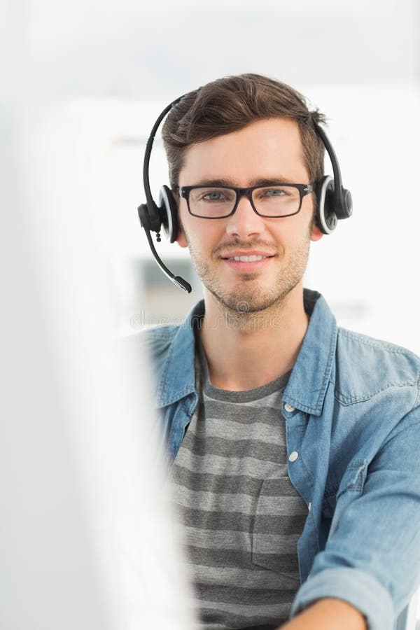 Portrait of a Smiling Man with Headset Using Computer Stock Image ...