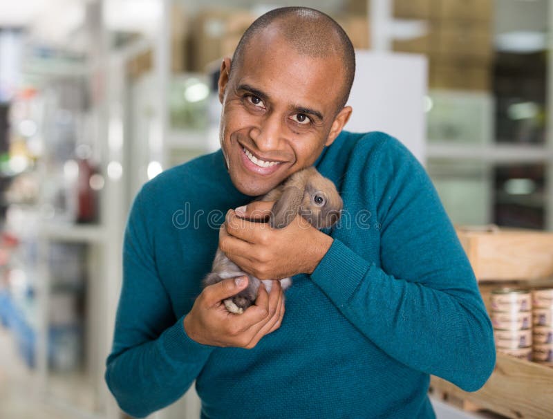 Portrait of Man Holding Rabbit in Hands Stock Photo - Image of shelf ...