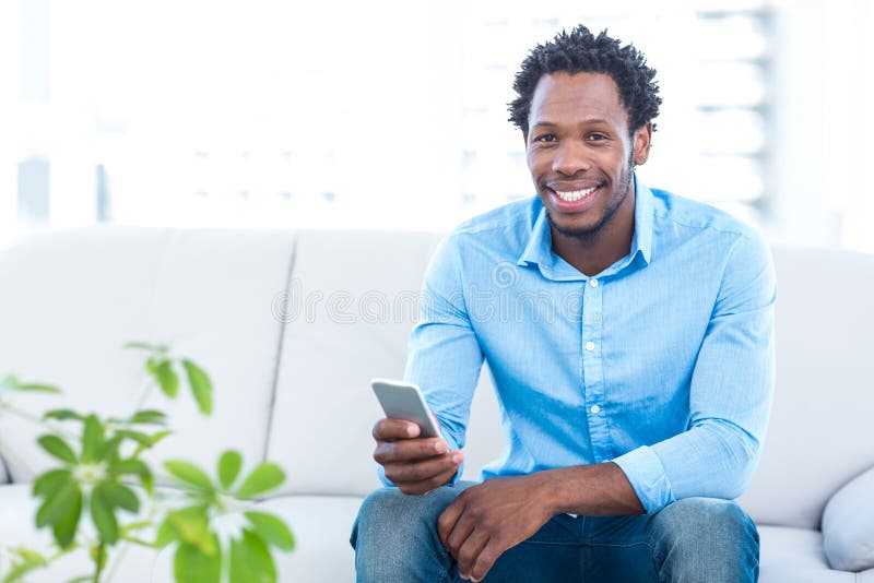 Portrait of Smiling Man Holding Smartphone at Home Stock Image - Image ...