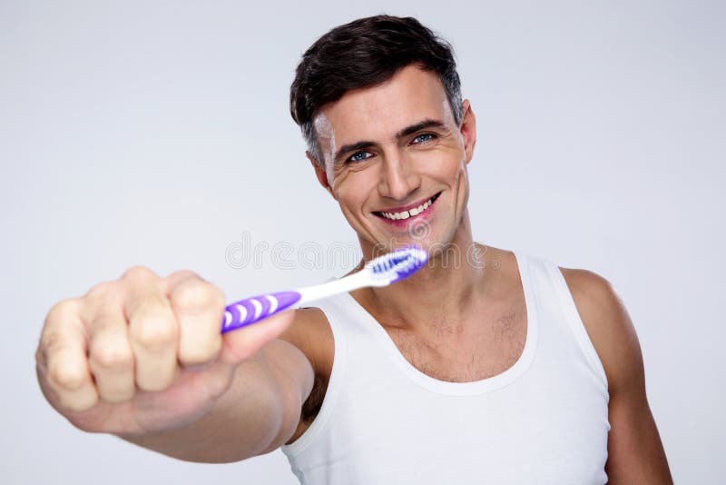 Portrait of a Smiling Man Holding Toothbrush Stock Photo - Image of ...