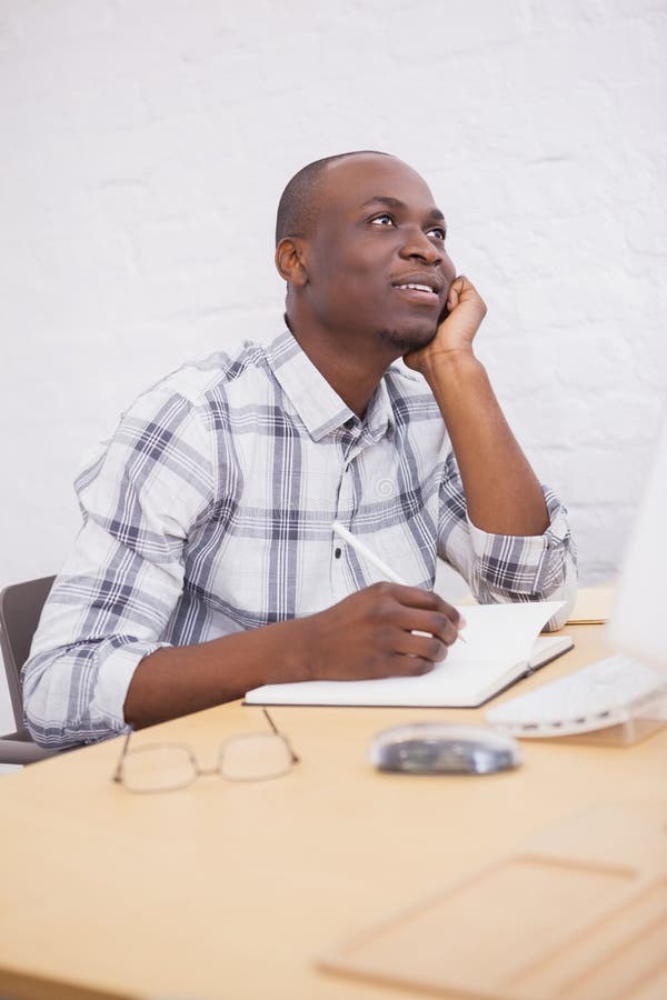 Portrait of a Smiling Man Thinking at His Desk Stock Photo - Image of ...