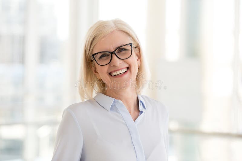 Portrait Of Smiling Middle Aged Businesswoman Posing For Picture Stock