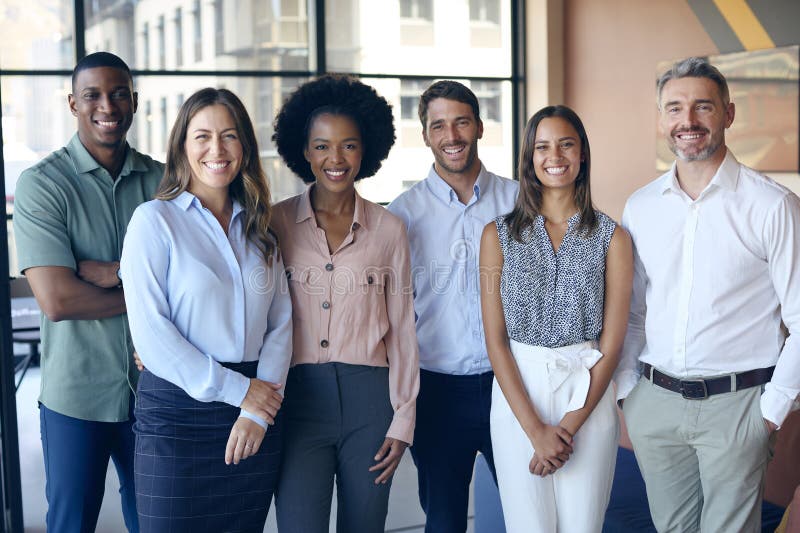 Portrait of Smiling Multi-Cultural Business Team Standing in Modern ...