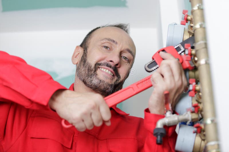 Portrait Smiling Plumber Using Wrench on Pipework Stock Photo - Image ...