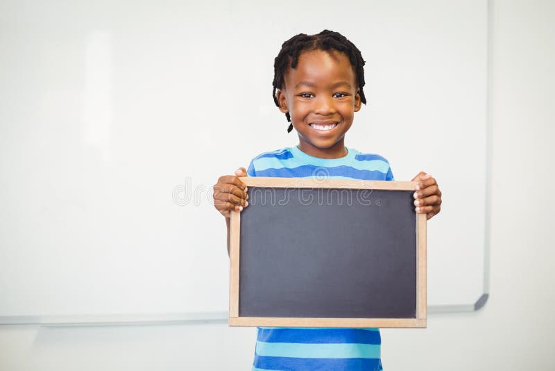 Portrait of Smiling School Boy Holding Slate in Classroom Stock Image ...