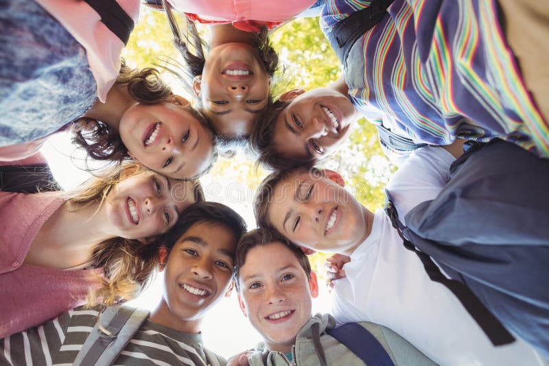 Portrait of Smiling School Kids Forming a Huddle in Campus Stock Image ...