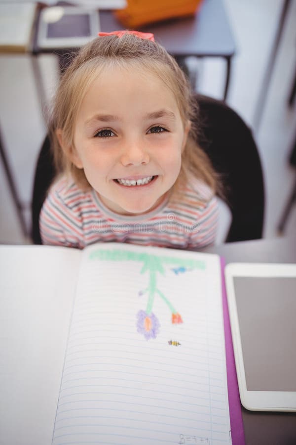 Portrait of Smiling Schoolgirl Sitting in Classroom Stock Photo - Image ...